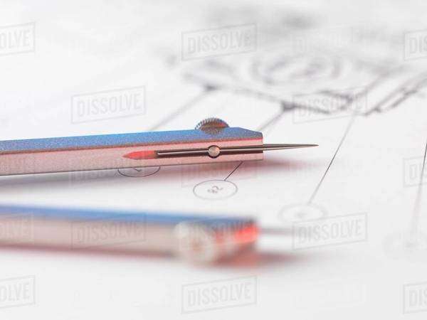 Dividers sitting on engineering drawing used in the measurement of ...
