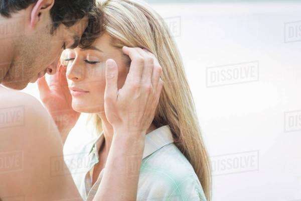 Young man touching woman's face - Stock Photo - Dissolve