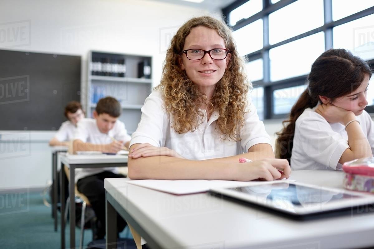 Portrait of schoolgirl in classroom - Royalty-free Stock Photo | Dissolve