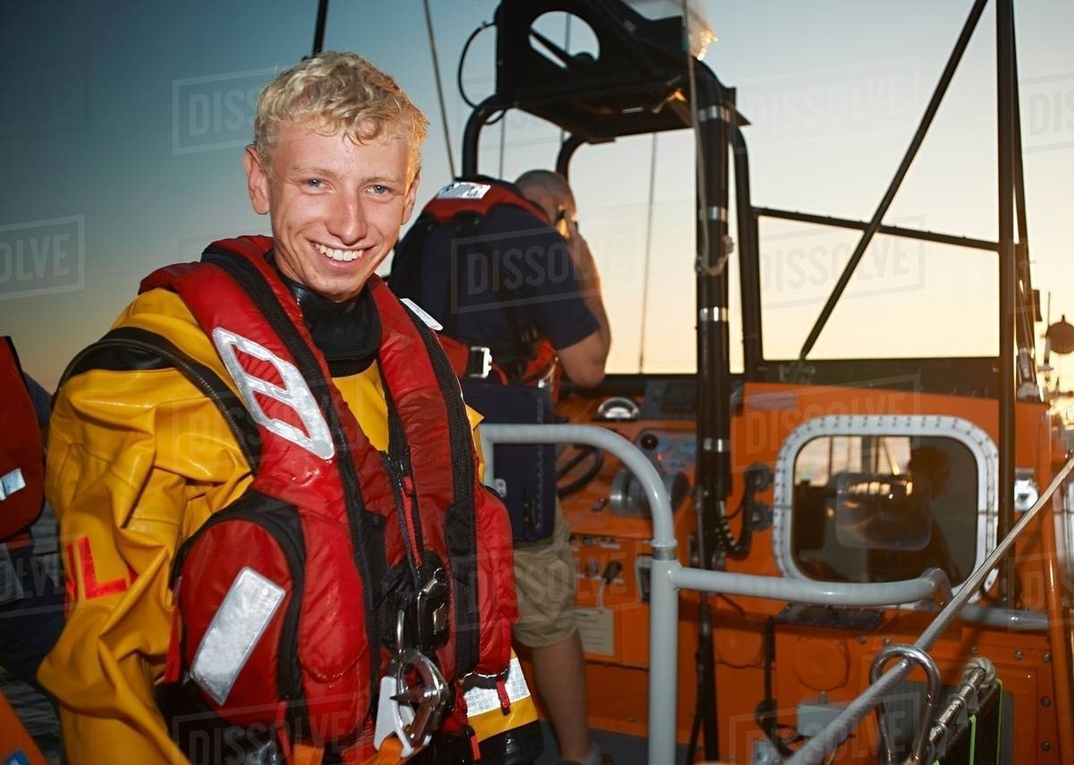 Portrait of young man crewing lifeboat at sea - Royalty-free Stock ...