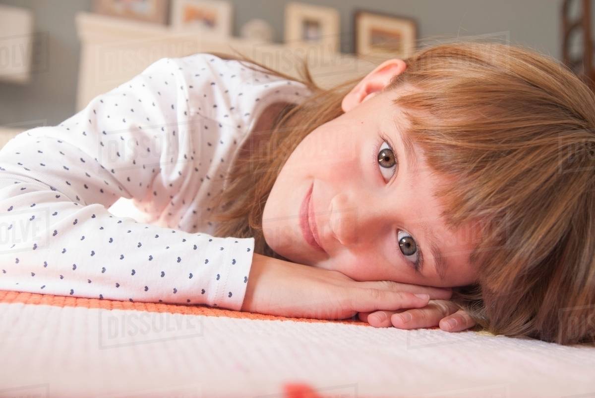 Close up portrait of girl lying on rug - Royalty-free Stock Photo ...