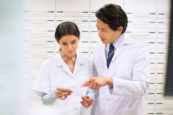 Pharmacists checking prescription in pharmacy - Royalty-free Stock ...