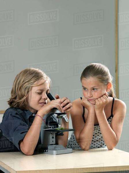 Two kids using microscope - Royalty-free Stock Photo | Dissolve