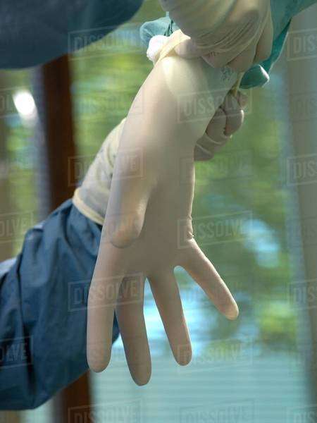 Hand with surgical gloves - Stock Photo - Dissolve