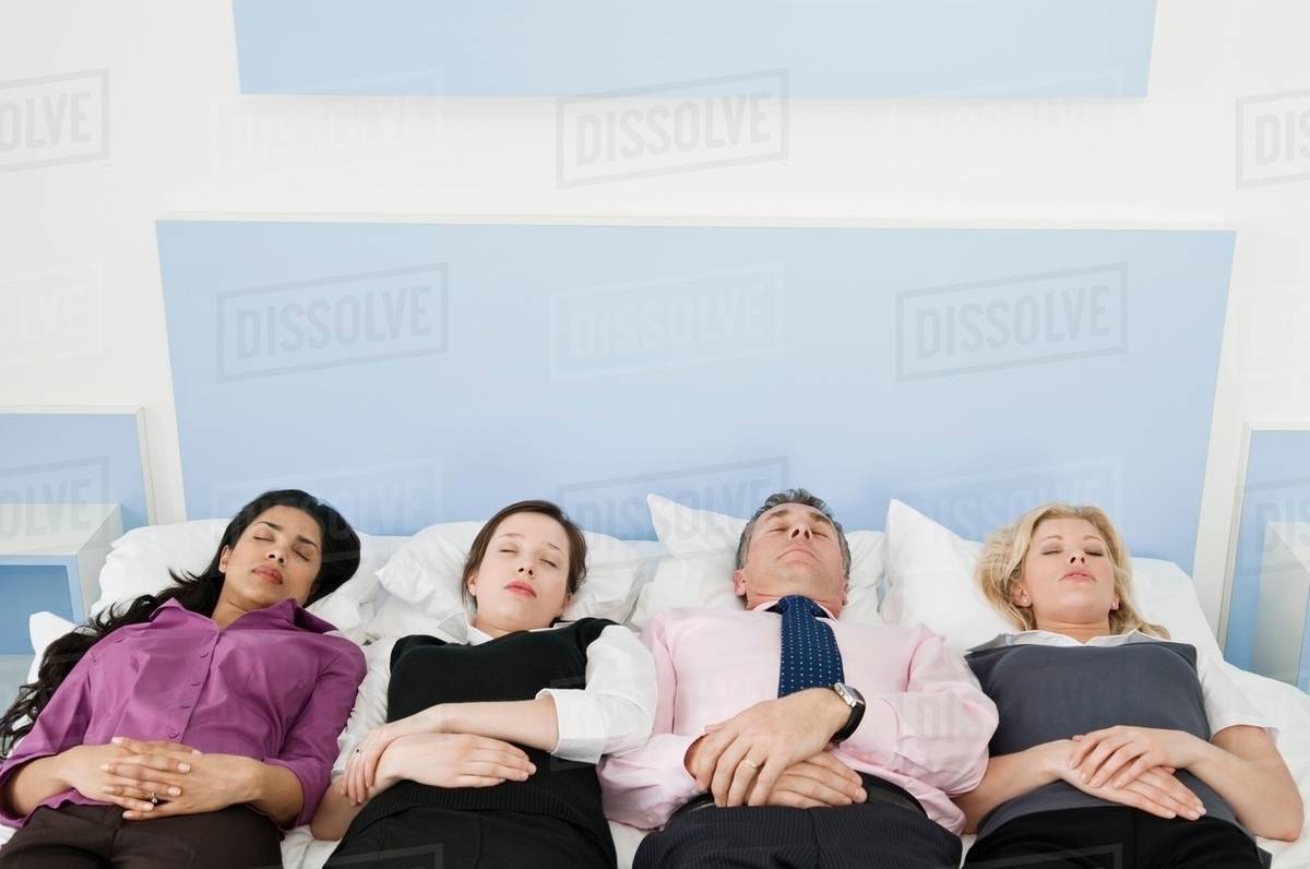 Four business people in a bed - Stock Photo - Dissolve