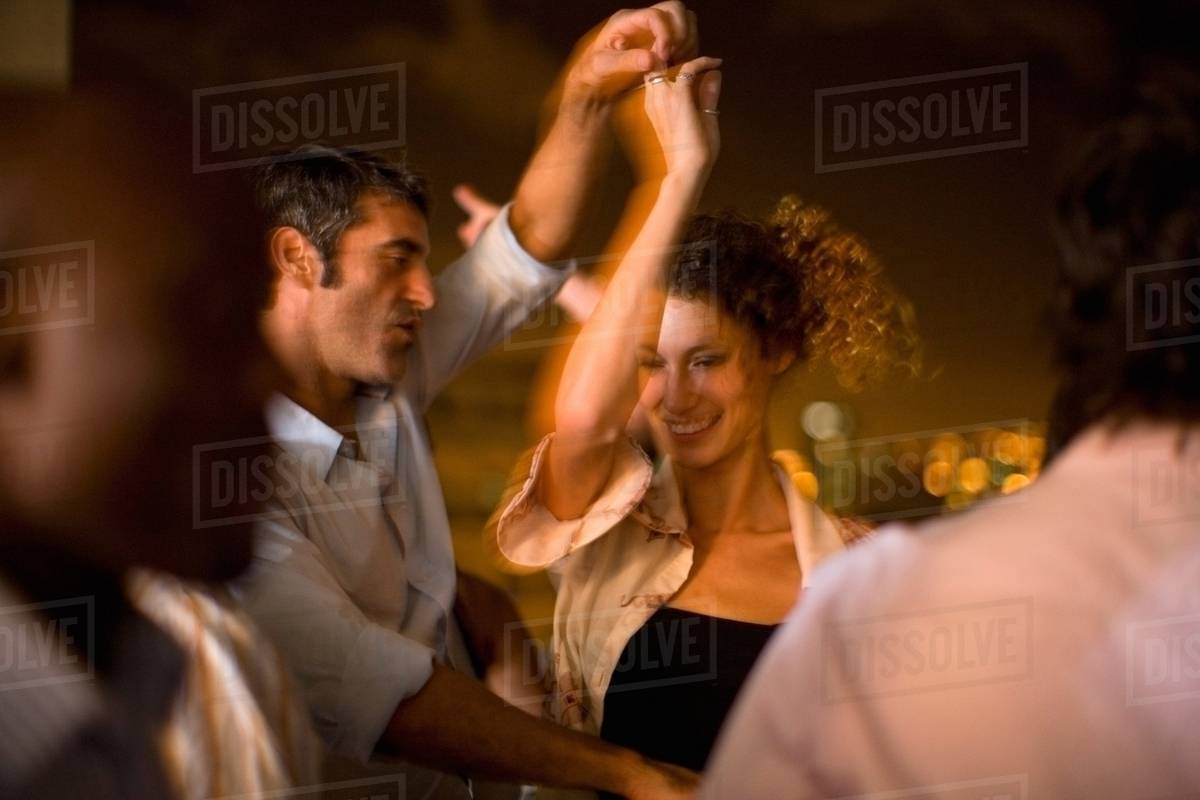Couple dancing at party at night - Royalty-free Stock Photo | Dissolve
