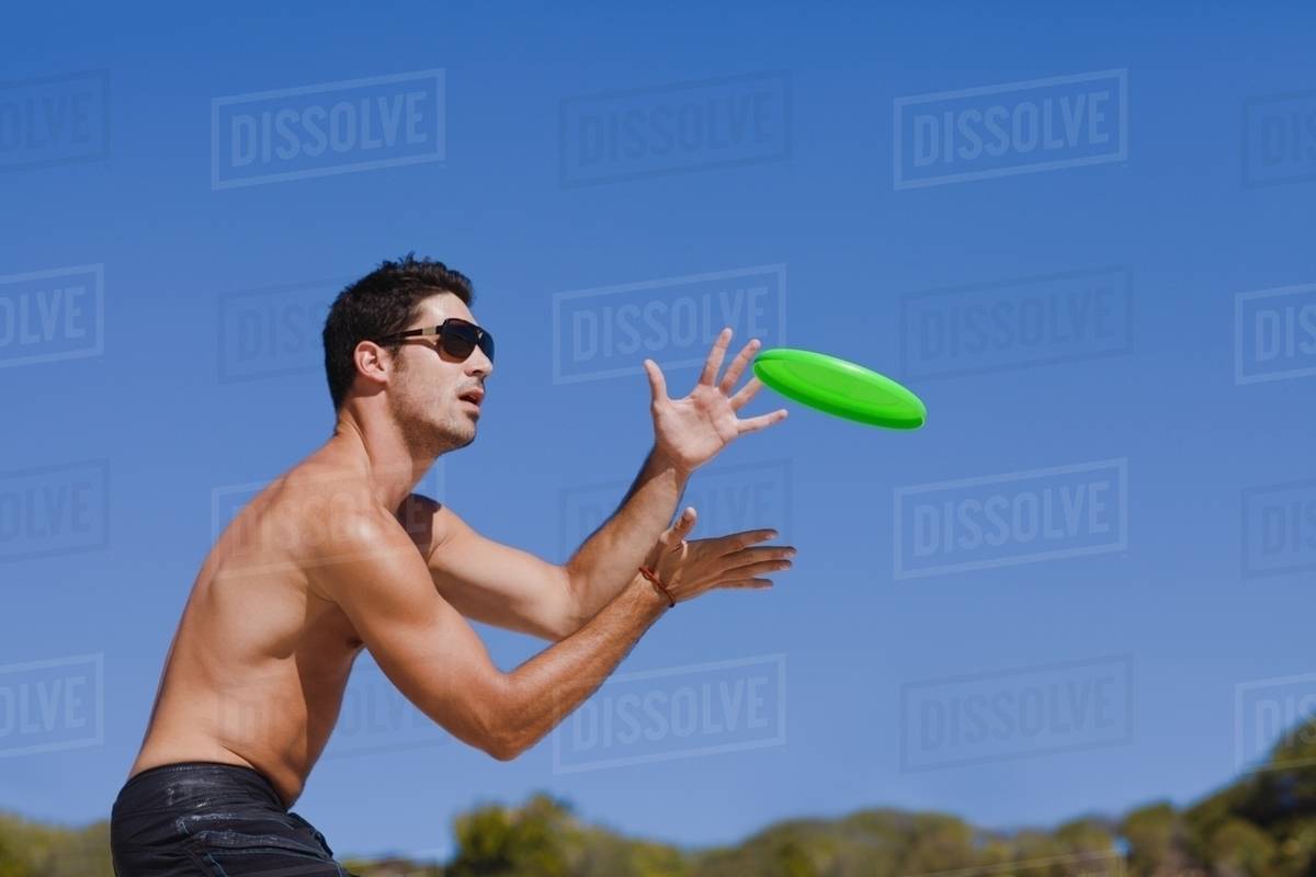 Man throwing a frisbee - Royalty-free Stock Photo | Dissolve