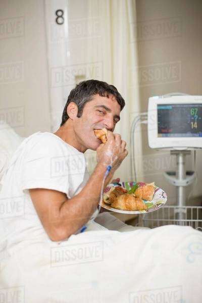 Hospital patient eating in bed - Royalty-free Stock Photo | Dissolve