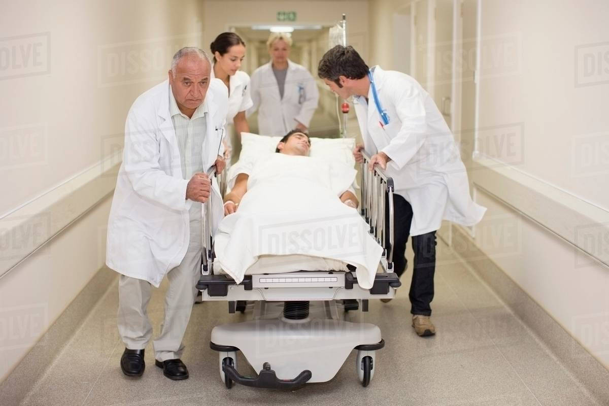 Doctors rushing patient down hallway - Royalty-free Stock Photo | Dissolve