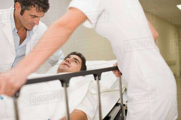 Doctors rushing patient down hallway - Royalty-free Stock Photo | Dissolve
