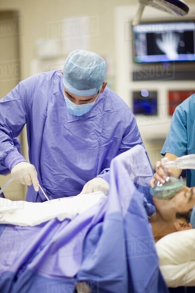 Doctor performing operation - Stock Photo - Dissolve