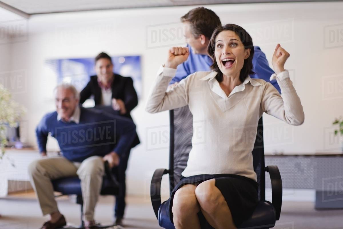 Business people having chair race - Stock Photo - Dissolve