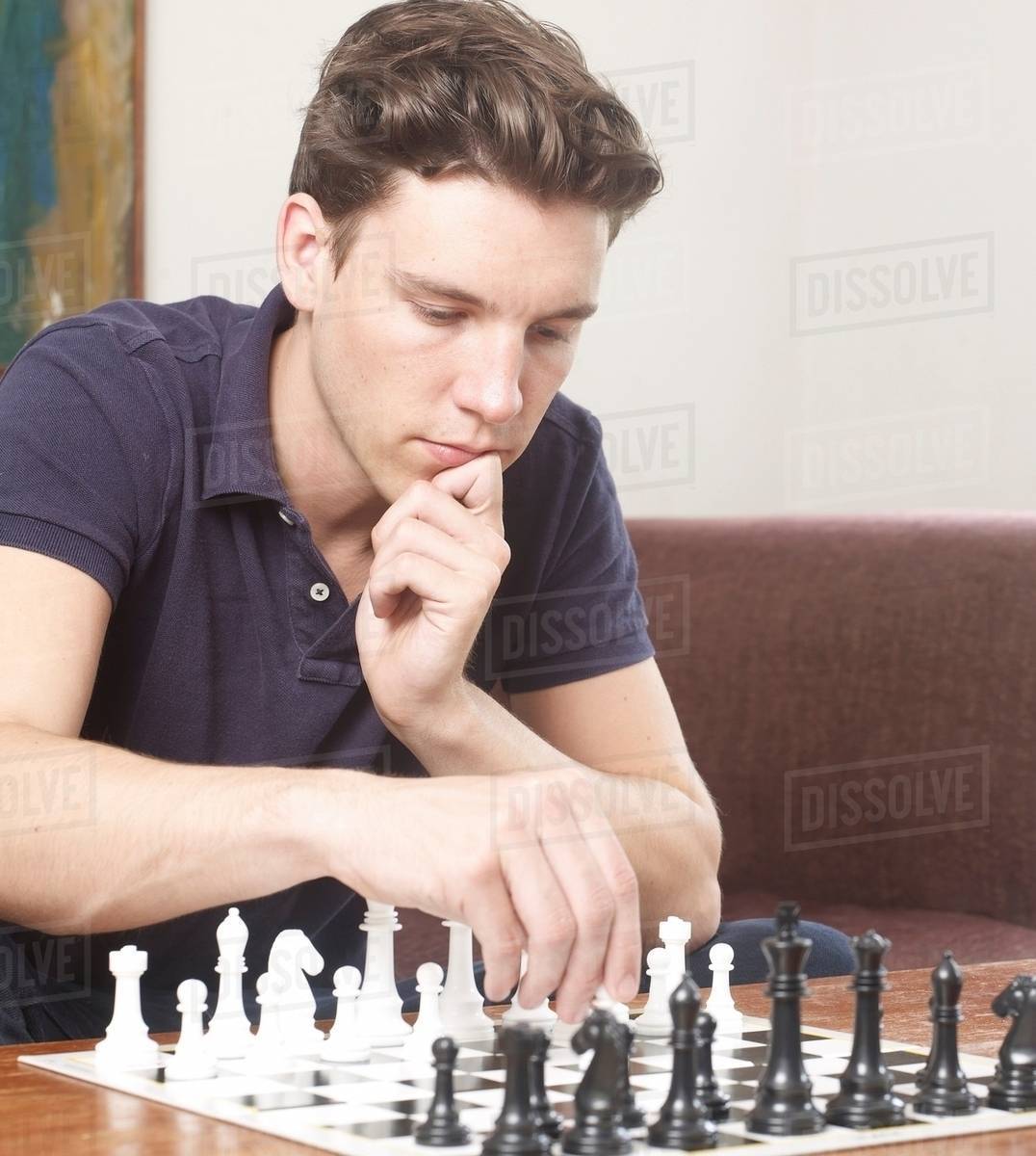 Thoughtful man playing chess - Royalty-free Stock Photo | Dissolve