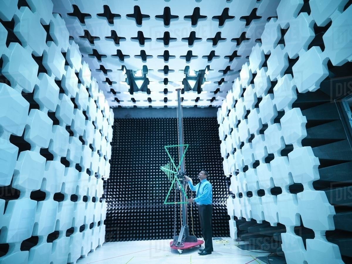 Engineer checking a bilog antenna's height for electromagnetic ...