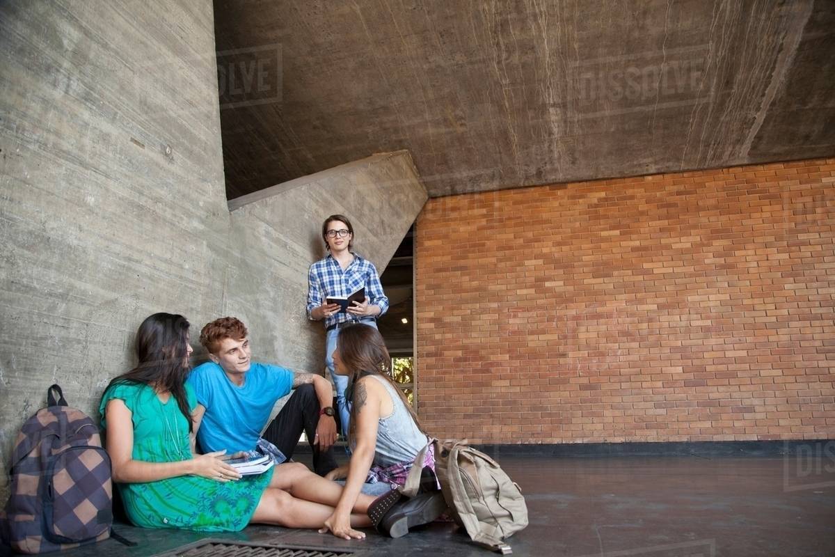 Three students talking - Royalty-free Stock Photo | Dissolve