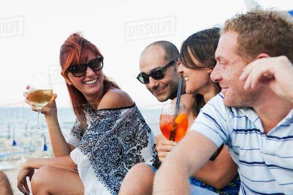 Friends drinking together outdoors - Royalty-free Stock Photo | Dissolve