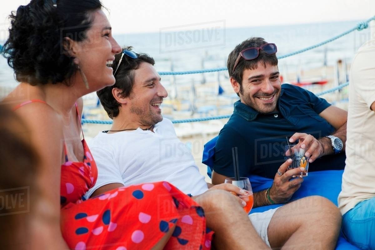 Friends drinking together outdoors - Stock Photo - Dissolve