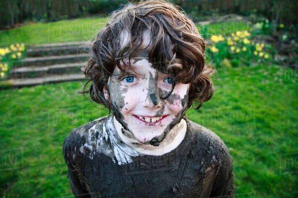 Boy's smiling face covered in mud - Royalty-free Stock Photo | Dissolve