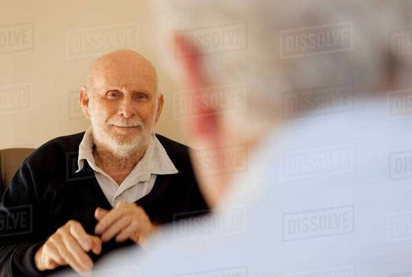 Older men talking indoors - Royalty-free Stock Photo | Dissolve