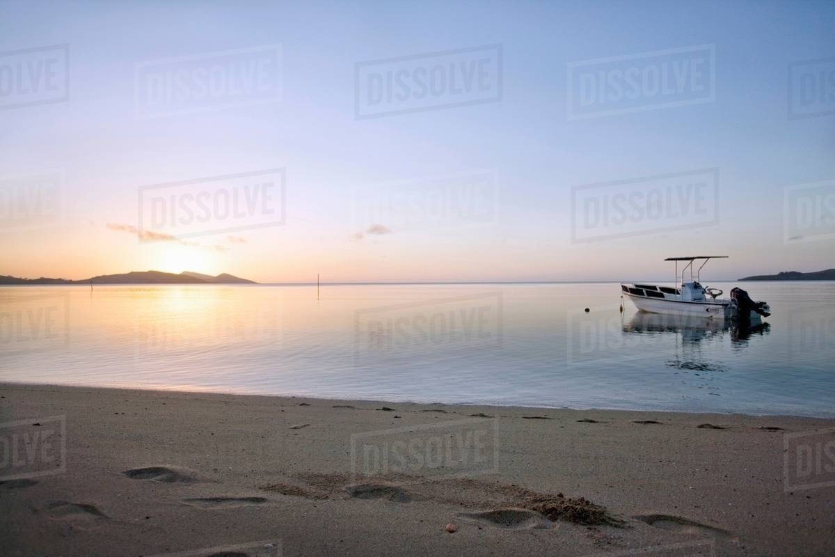 Boat in still ocean - Royalty-free Stock Photo | Dissolve