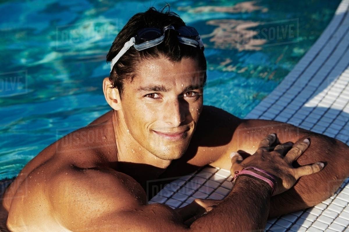 Man relaxing on edge of pool - Royalty-free Stock Photo | Dissolve