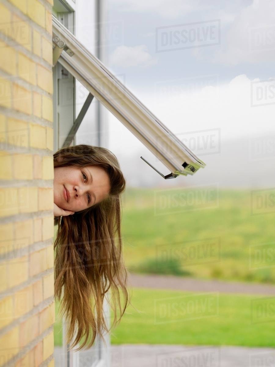 Girl peering outside window - Stock Photo - Dissolve