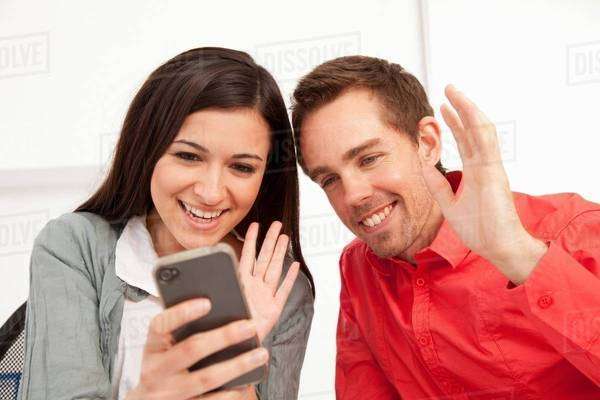 Business people using cell phone - Stock Photo - Dissolve