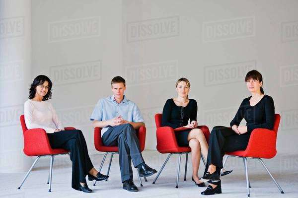 Business people sitting in office chairs - Stock Photo - Dissolve