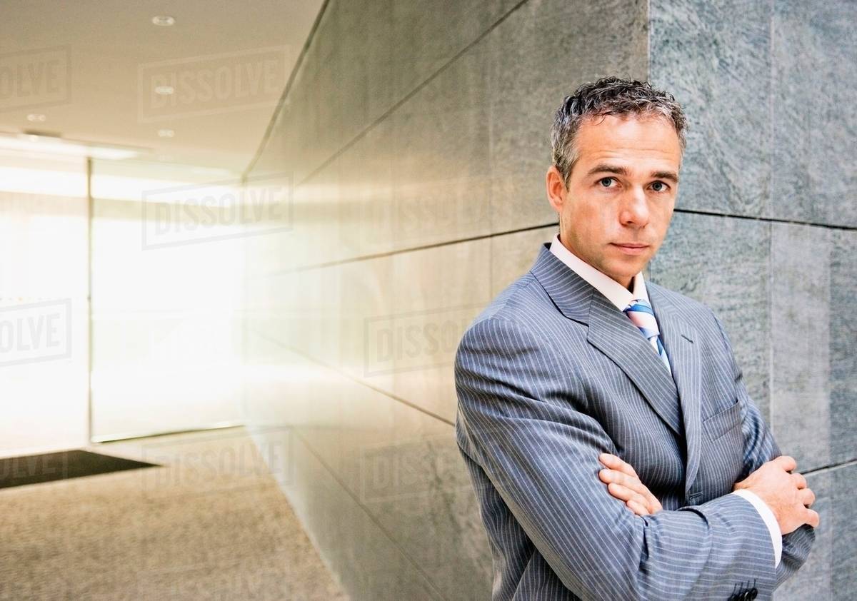 Businessman standing in office - Stock Photo - Dissolve