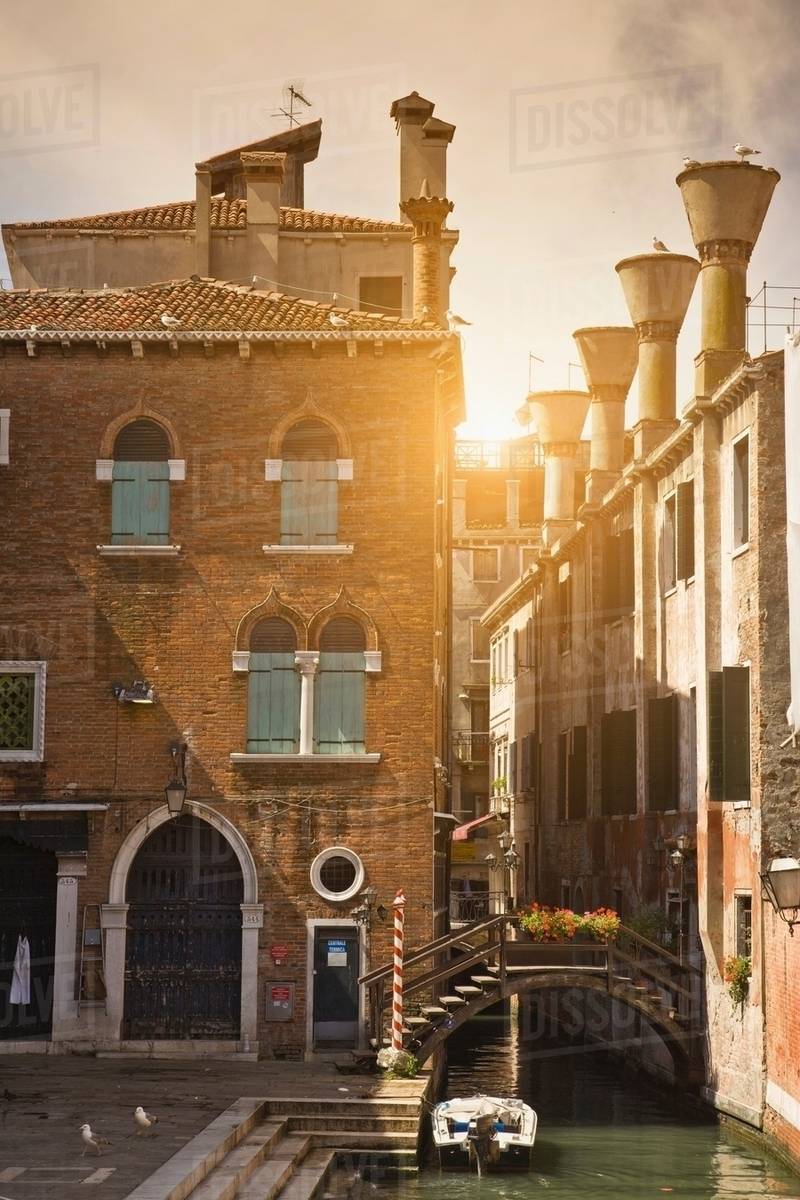 Buildings and bridge on urban canal - Stock Photo - Dissolve