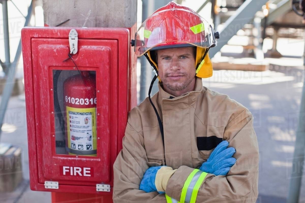 Firefighter smiling on site - Royalty-free Stock Photo | Dissolve