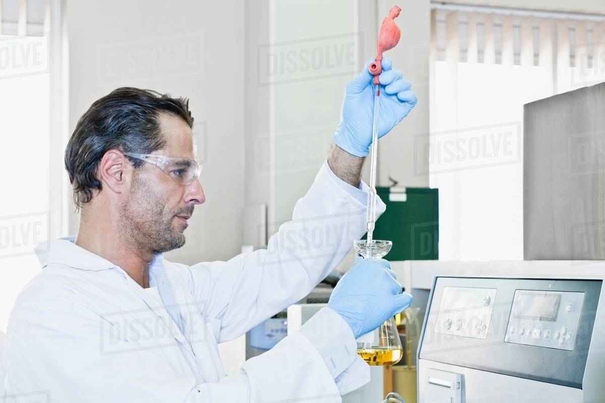 Scientist with pipette of liquid - Royalty-free Stock Photo | Dissolve