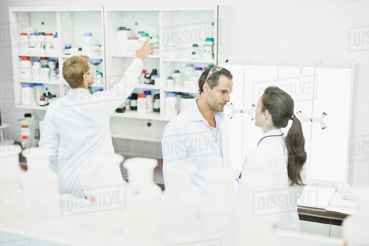 Scientists talking in lab - Stock Photo - Dissolve