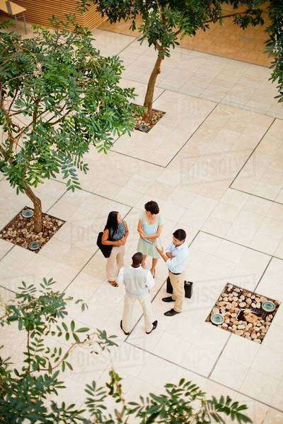 Business people talking in lobby - Royalty-free Stock Photo | Dissolve