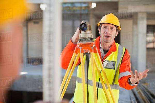 Workers using equipment on site - Royalty-free Stock Photo | Dissolve