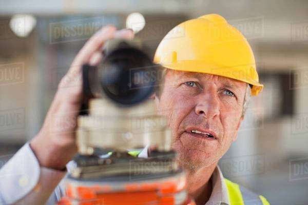 Worker using equipment on site - Royalty-free Stock Photo | Dissolve