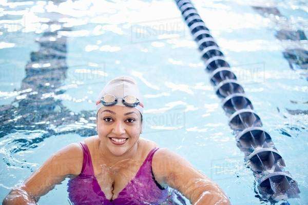 Woman at edge of swimming pool - Royalty-free Stock Photo | Dissolve