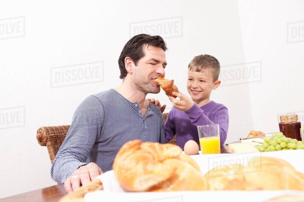 Father and son eating breakfast - Royalty-free Stock Photo | Dissolve