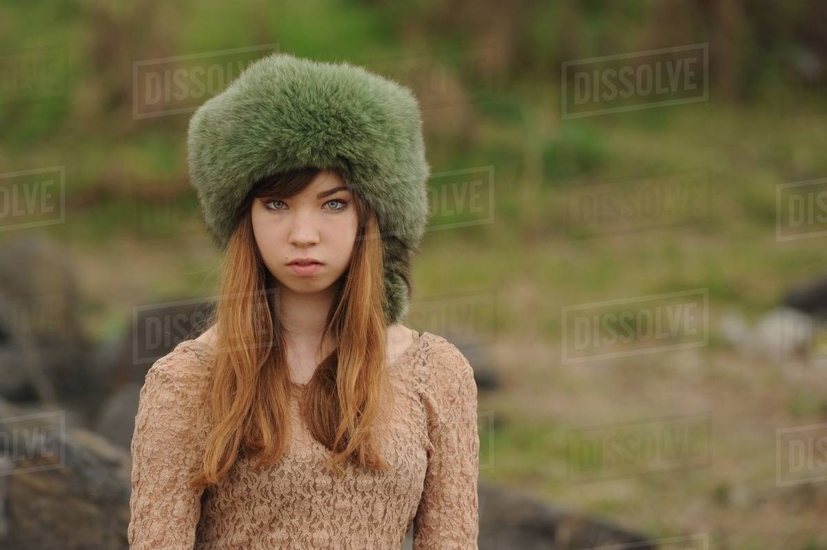 Teenage girl wearing fur hat outdoors - Royalty-free Stock Photo | Dissolve