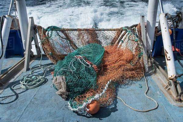Trawler net on deck of research ship - Stock Photo - Dissolve