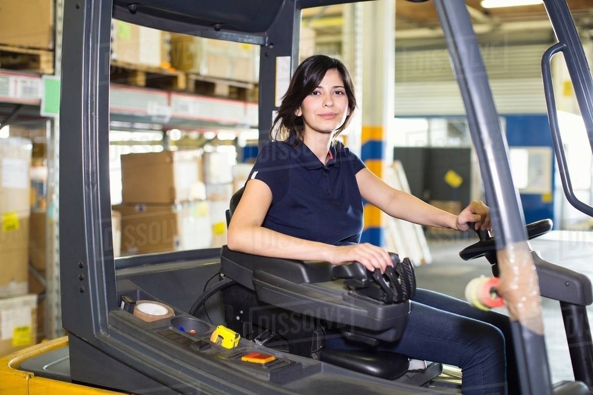 Portrait of female forklift truck driver working in distribution ...