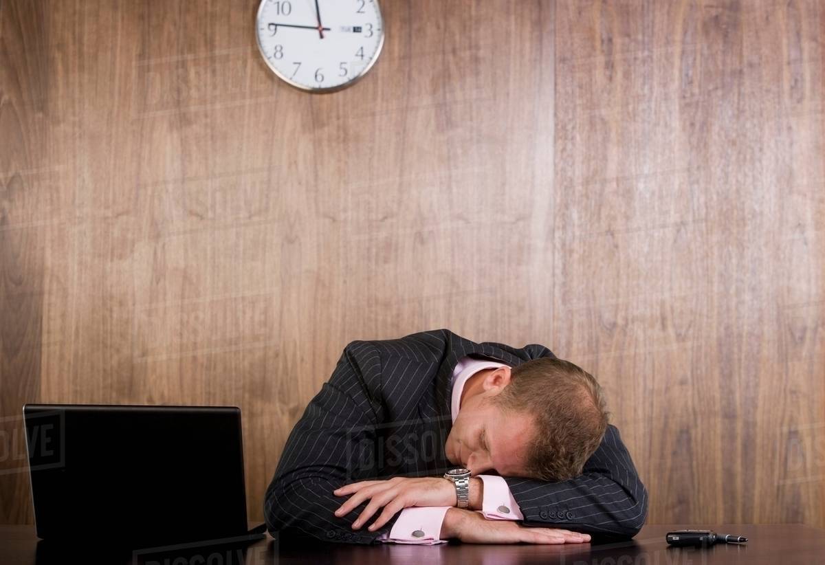 Business man asleep at his desk - Royalty-free Stock Photo | Dissolve