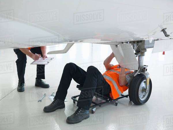 Engineers working on jet aircraft - Stock Photo - Dissolve