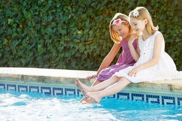 Girls playing by the pool - Royalty-free Stock Photo | Dissolve