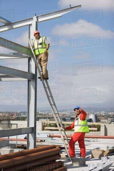 Worker standing on ladder - Stock Photo - Dissolve
