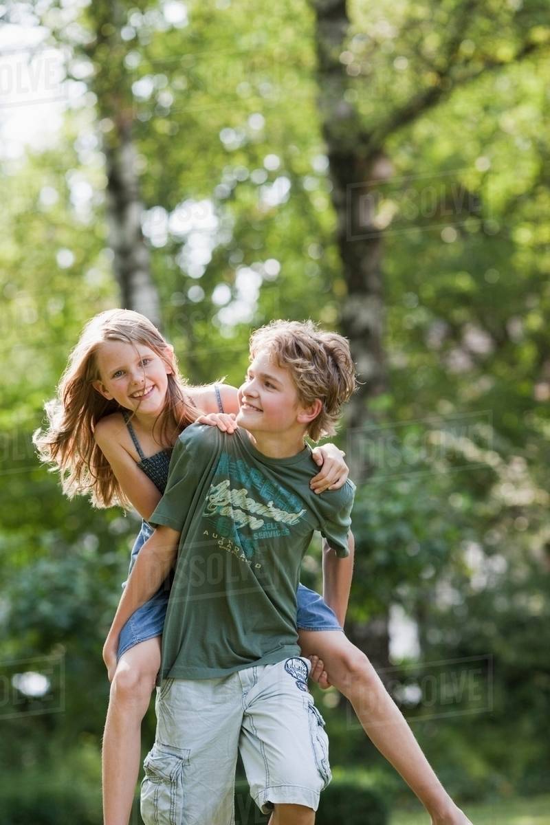 Girl riding on boy's back - Royalty-free Stock Photo | Dissolve