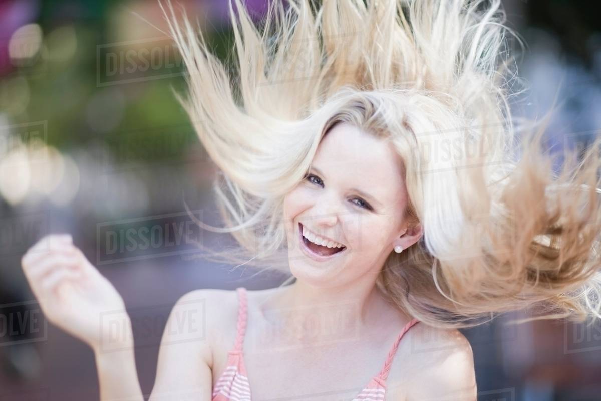 Blond girl shaking her hair - Royalty-free Stock Photo | Dissolve