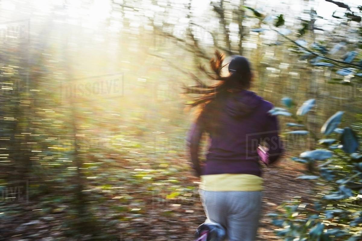 Girl running through forest in the sun - Royalty-free Stock Photo ...