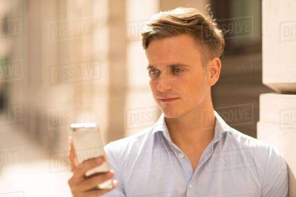 Man texting in street, close up - Royalty-free Stock Photo | Dissolve