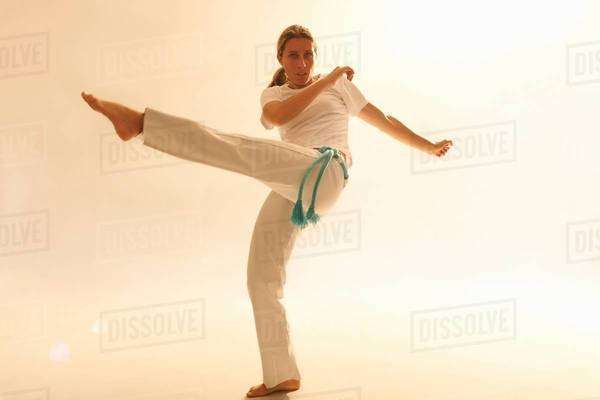 Woman practising capoeira - Royalty-free Stock Photo | Dissolve